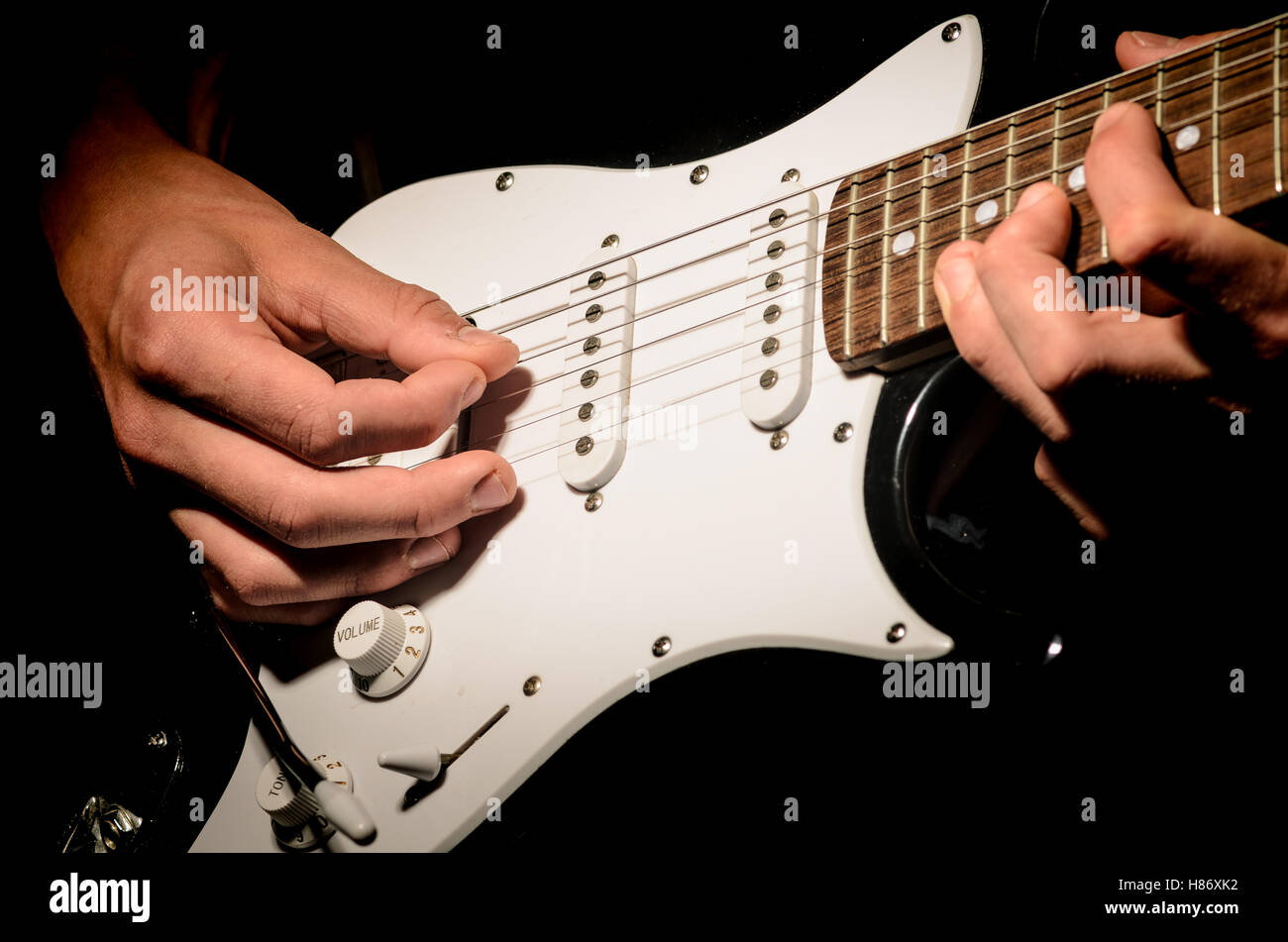 Hands playing guitar Stock Photo - Alamy