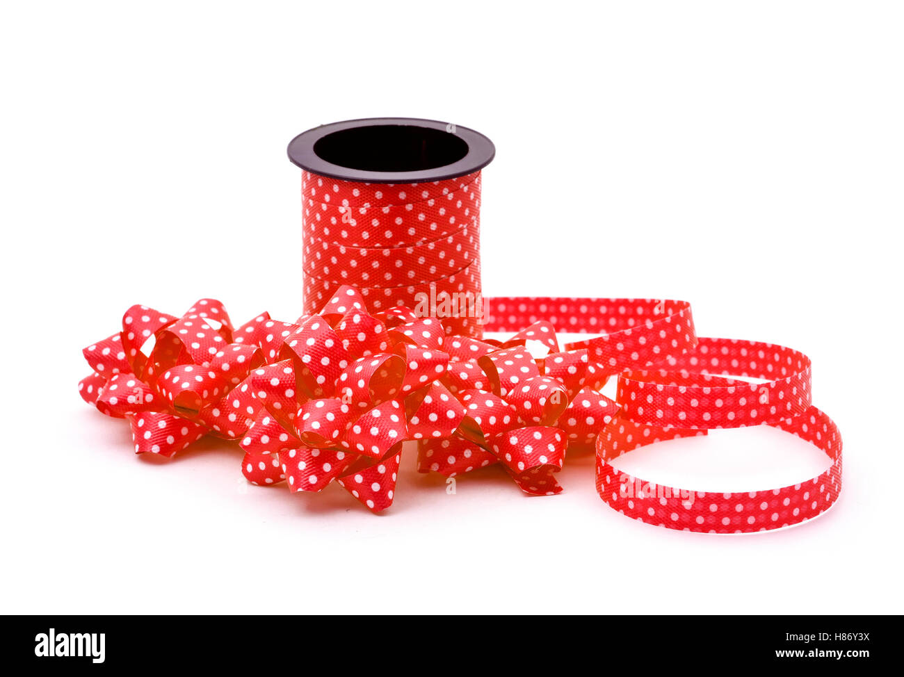 some gift puff bows made with red ribbon patterned with white dots and ...