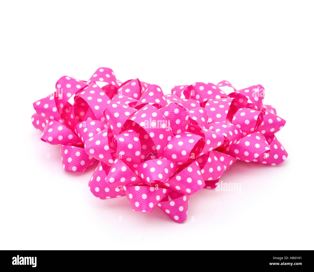some gift puff bows made with pink ribbon patterned with white dots, on ...