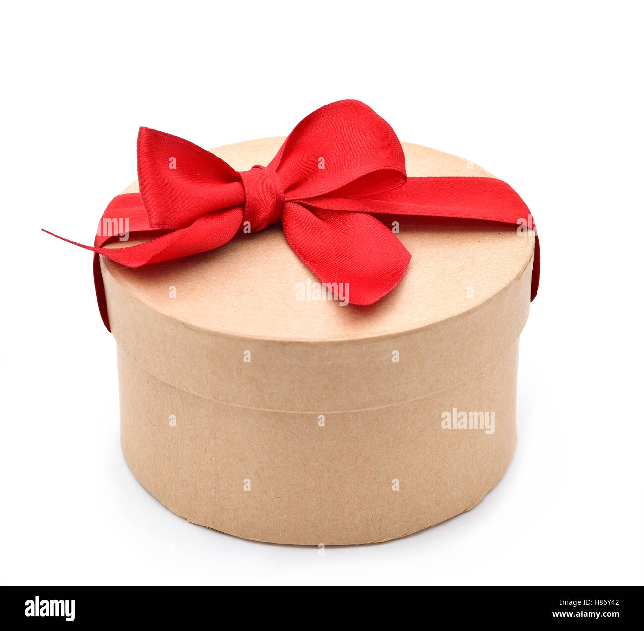 a round gift box with a red ribbon bow on a white background Stock ...