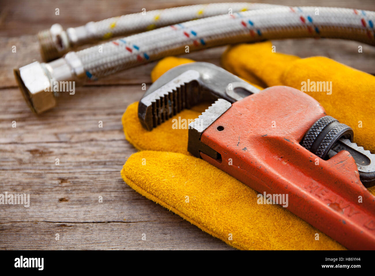 Set of plumbing and tools on the table. Fitting, suede gloves and ...