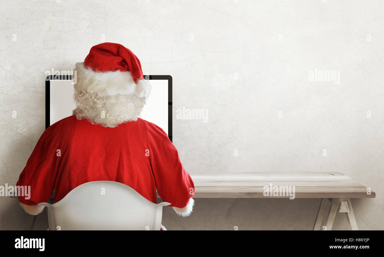 Santa Claus responds to letter of wishes on a computer. Front view of ...