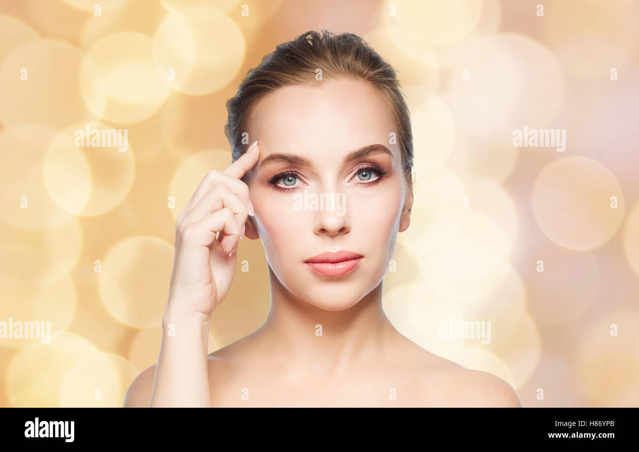 Beautiful woman pointing forehead hi-res stock photography and images ...