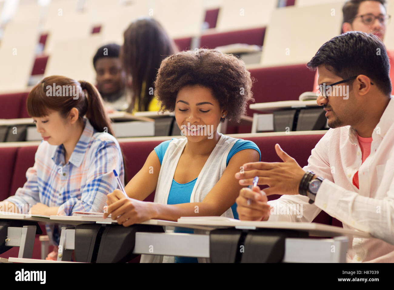 group of students with notebooks in lecture hall Stock Photo - Alamy