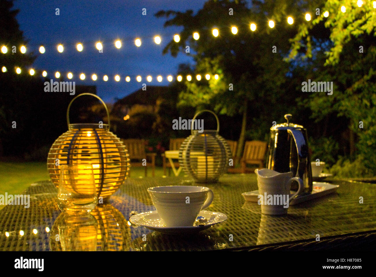 Late summer evening in an English garden with decorative lights Stock ...