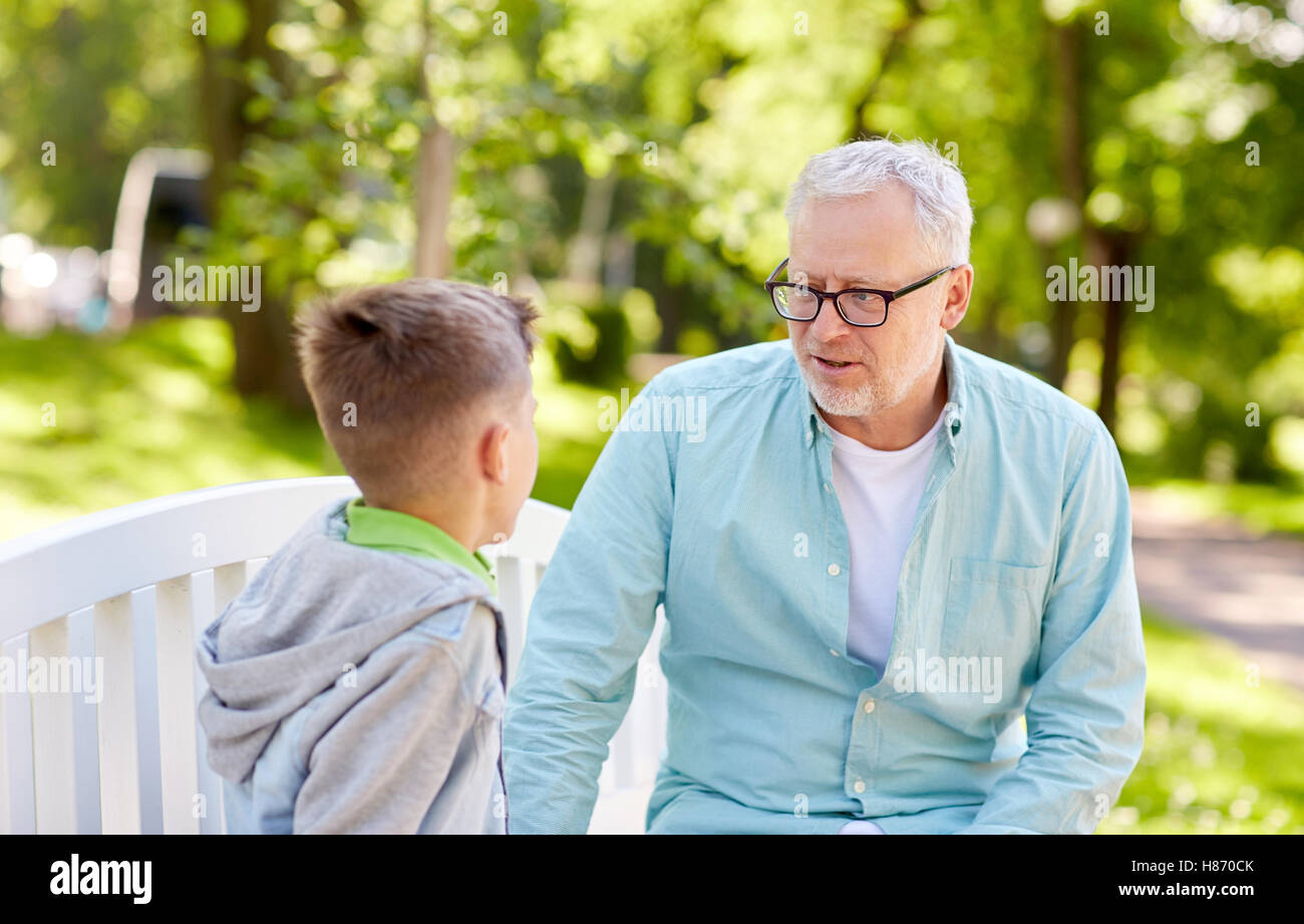 grandfather and grandson talking at summer park Stock Photo - Alamy