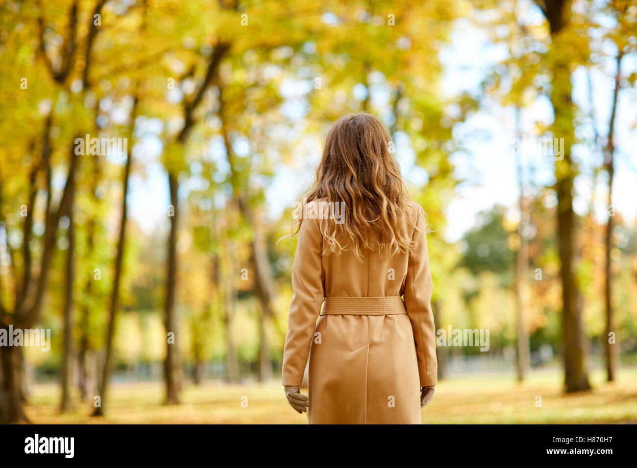 beautiful young woman walking in autumn park Stock Photo - Alamy