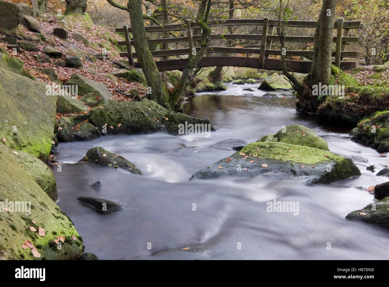 Longshaw Estate footbridge across Burbage Brook as it begins its ...