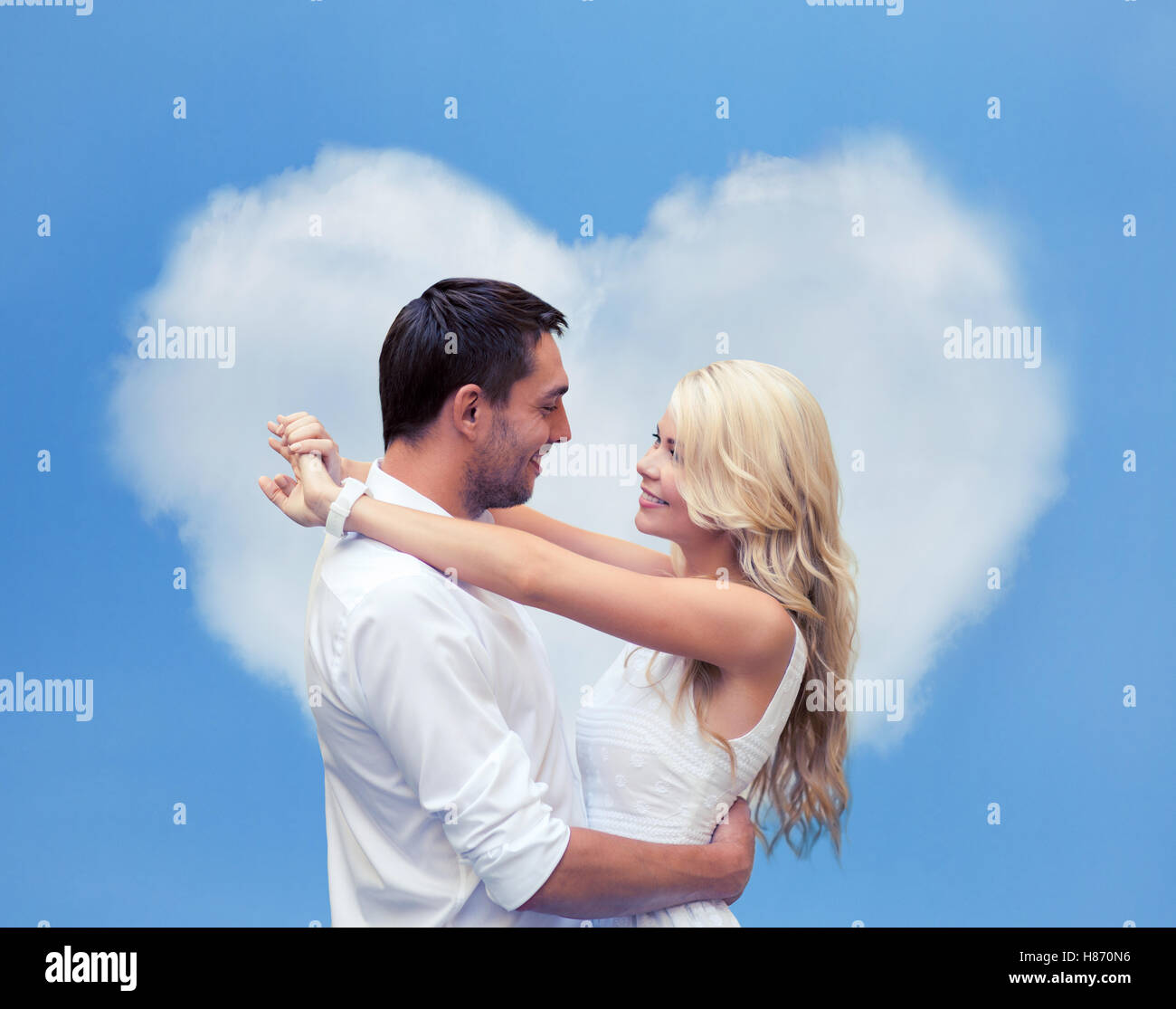 happy couple hugging over heart shaped cloud Stock Photo - Alamy