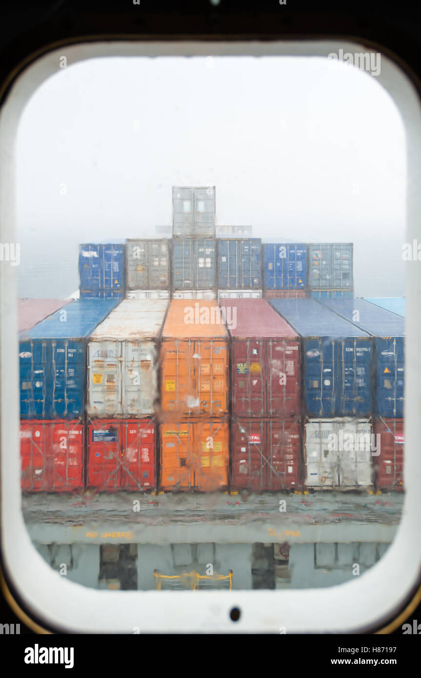 View throught the porthole of a container ship Stock Photo - Alamy