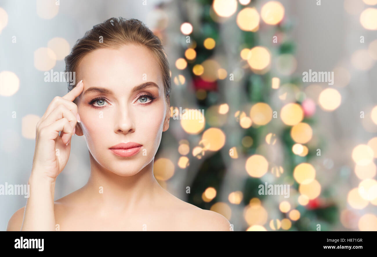 beautiful woman face over christmas lights Stock Photo - Alamy