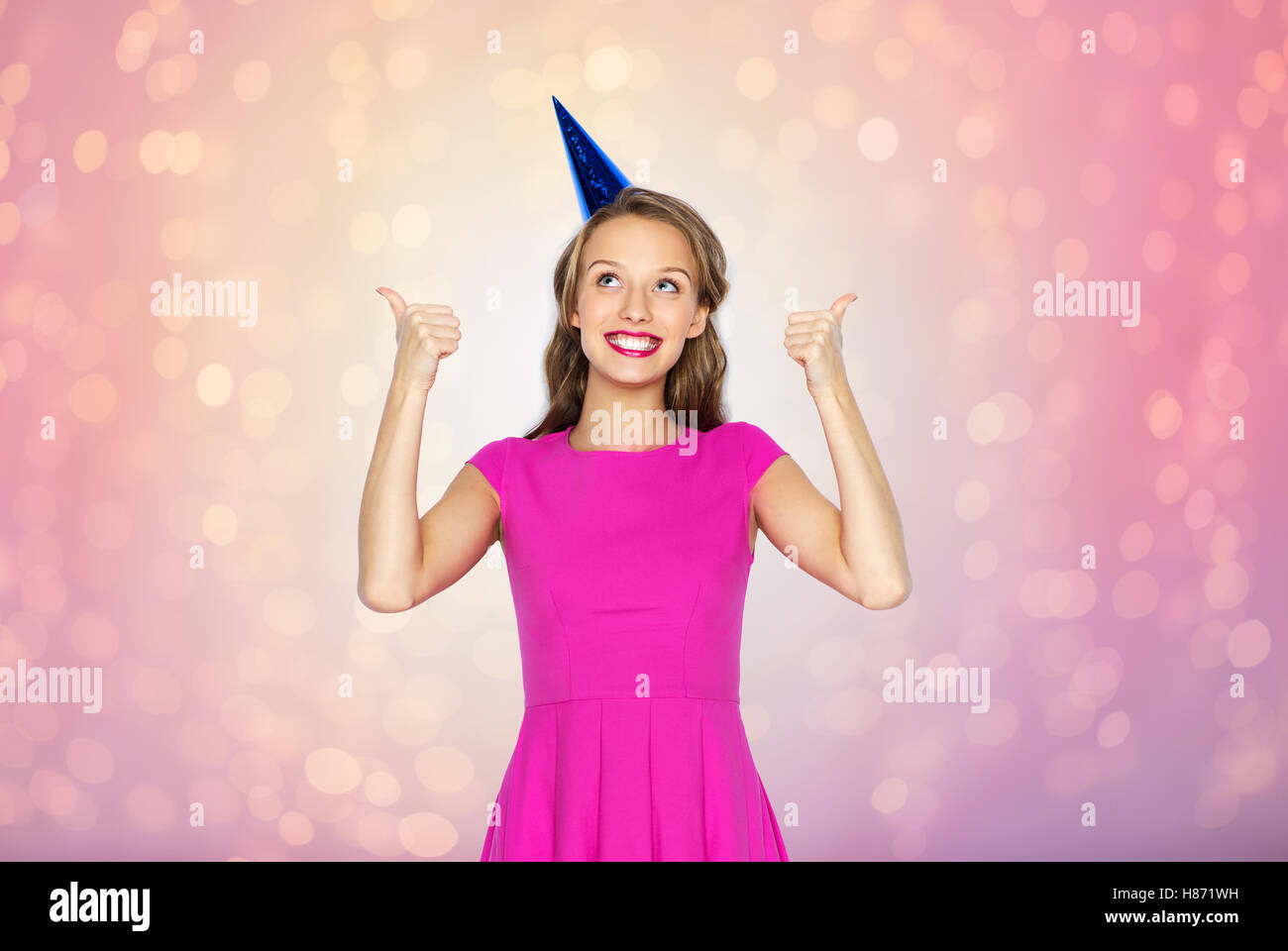 happy young woman or teen girl in party cap Stock Photo - Alamy