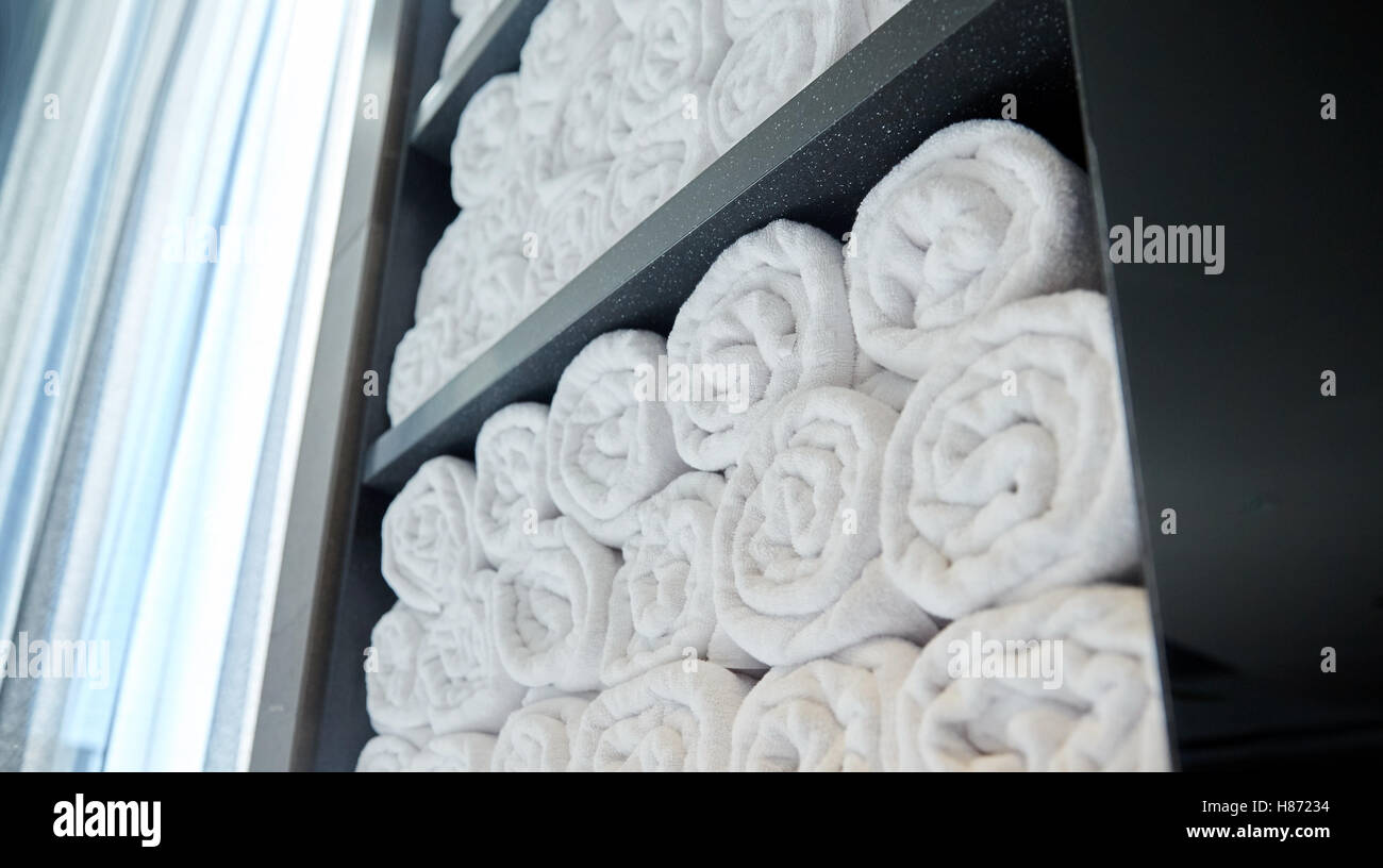 rolled white bath towels at hotel spa Stock Photo - Alamy