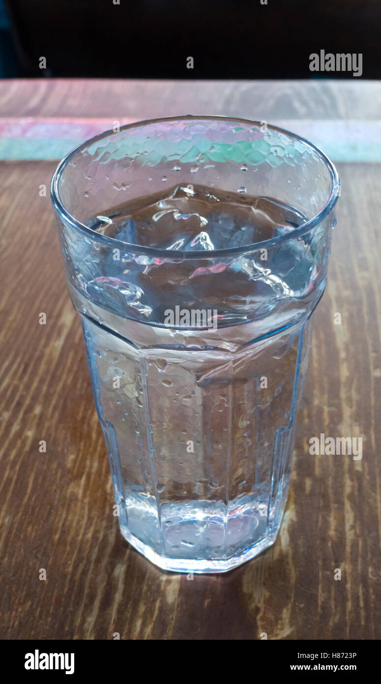 A plastic glass with ice water on an old wooden table H2O Stock Photo ...
