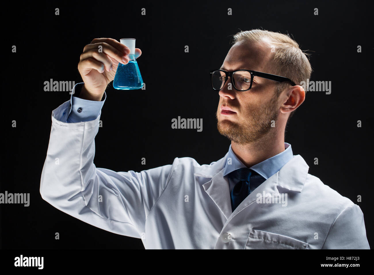 Scientist looking flask blue liquid hi-res stock photography and images ...