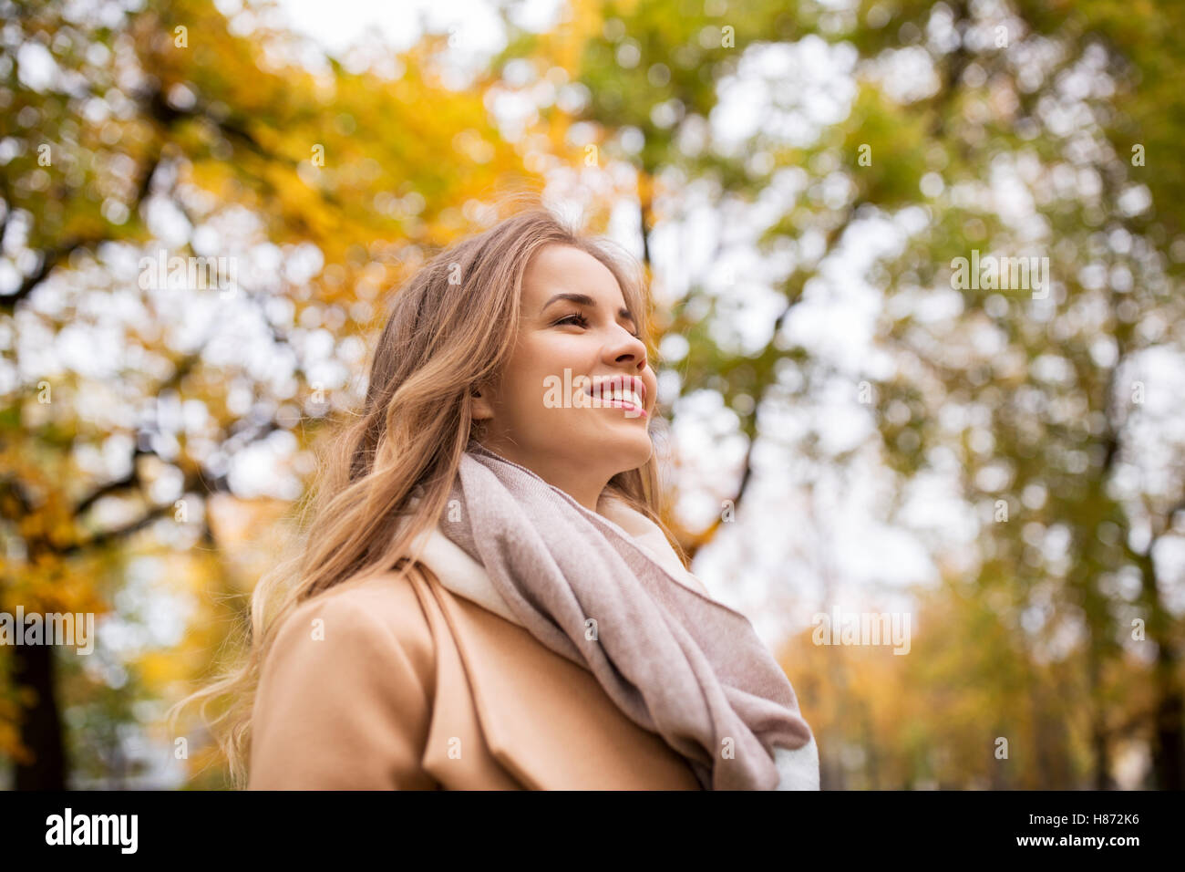 beautiful happy young woman walking in autumn park Stock Photo - Alamy