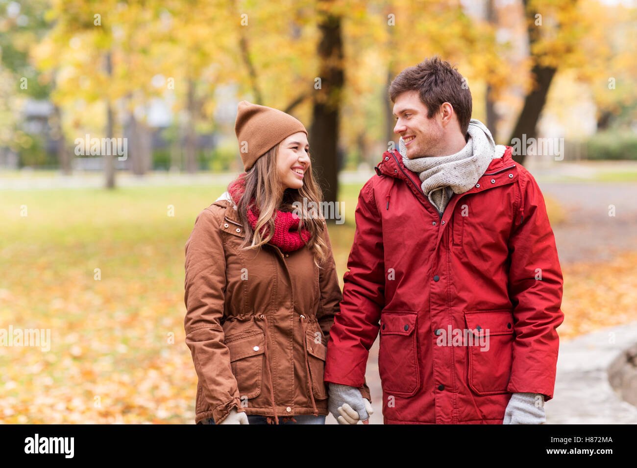 happy young couple walking in autumn park Stock Photo - Alamy
