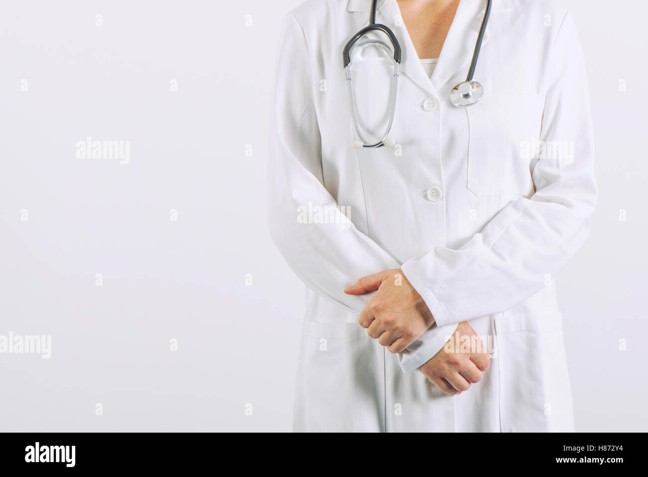 Female doctor posing confident in white medical uniform, general ...