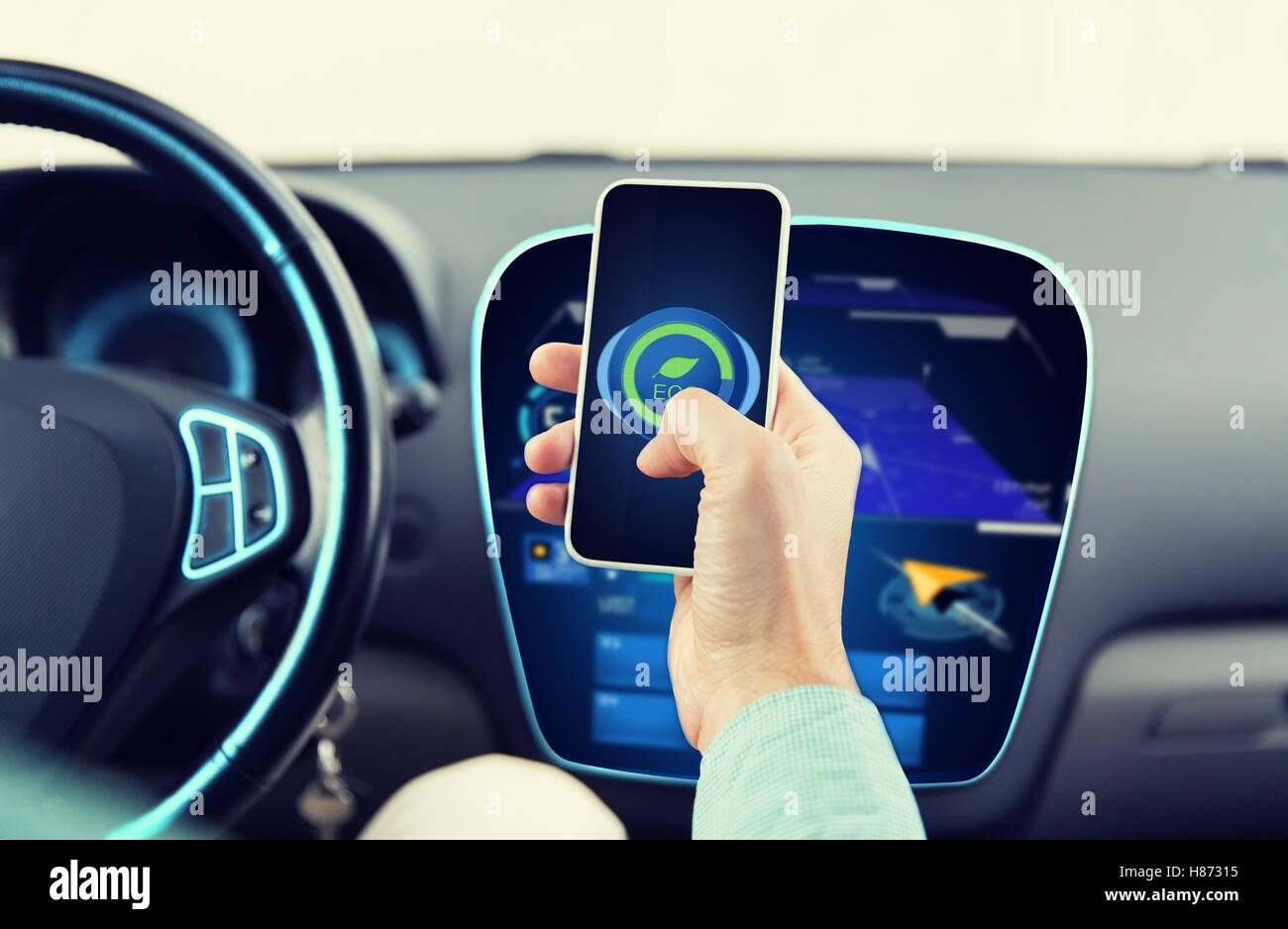 man driving car and setting eco mode on smartphone Stock Photo - Alamy