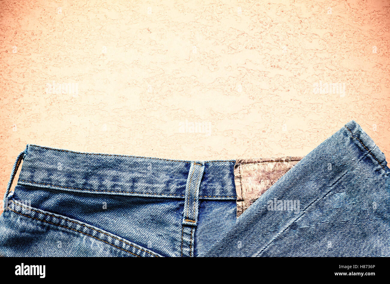 Old blue jeans on a concrete floor Stock Photo - Alamy