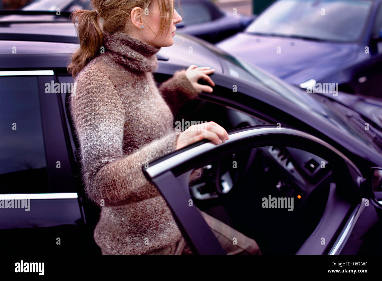 Young women Driver getting into Motor Car Stock Photo - Alamy