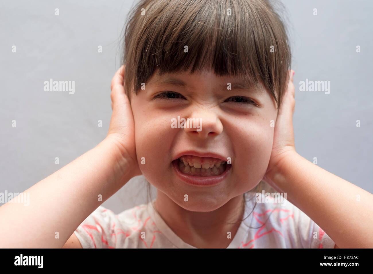 Girl holding hands over her ears hi-res stock photography and images ...