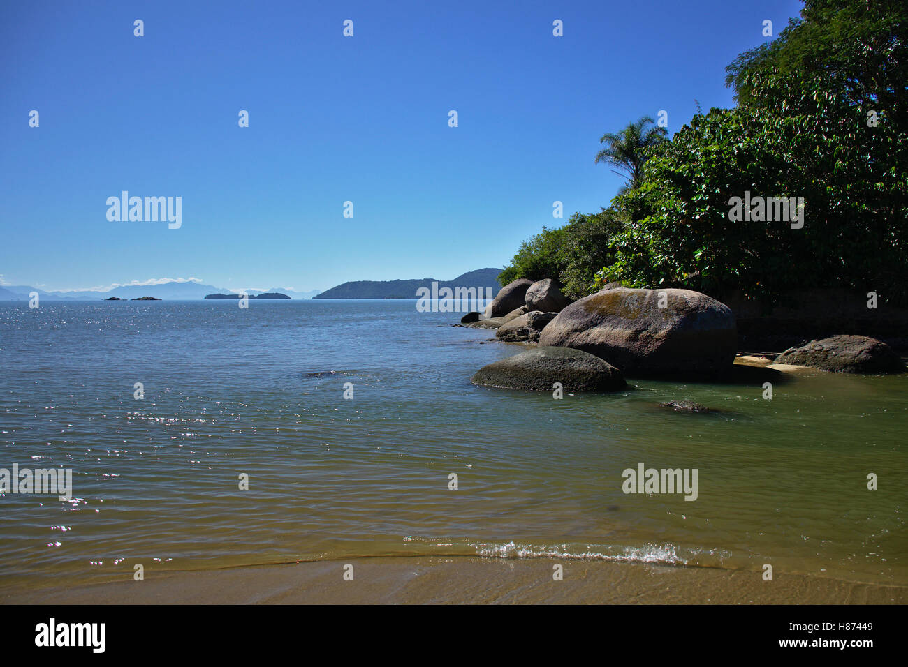 Wild seashore with sand, rocks and forest in Rio de Janeiro state ...