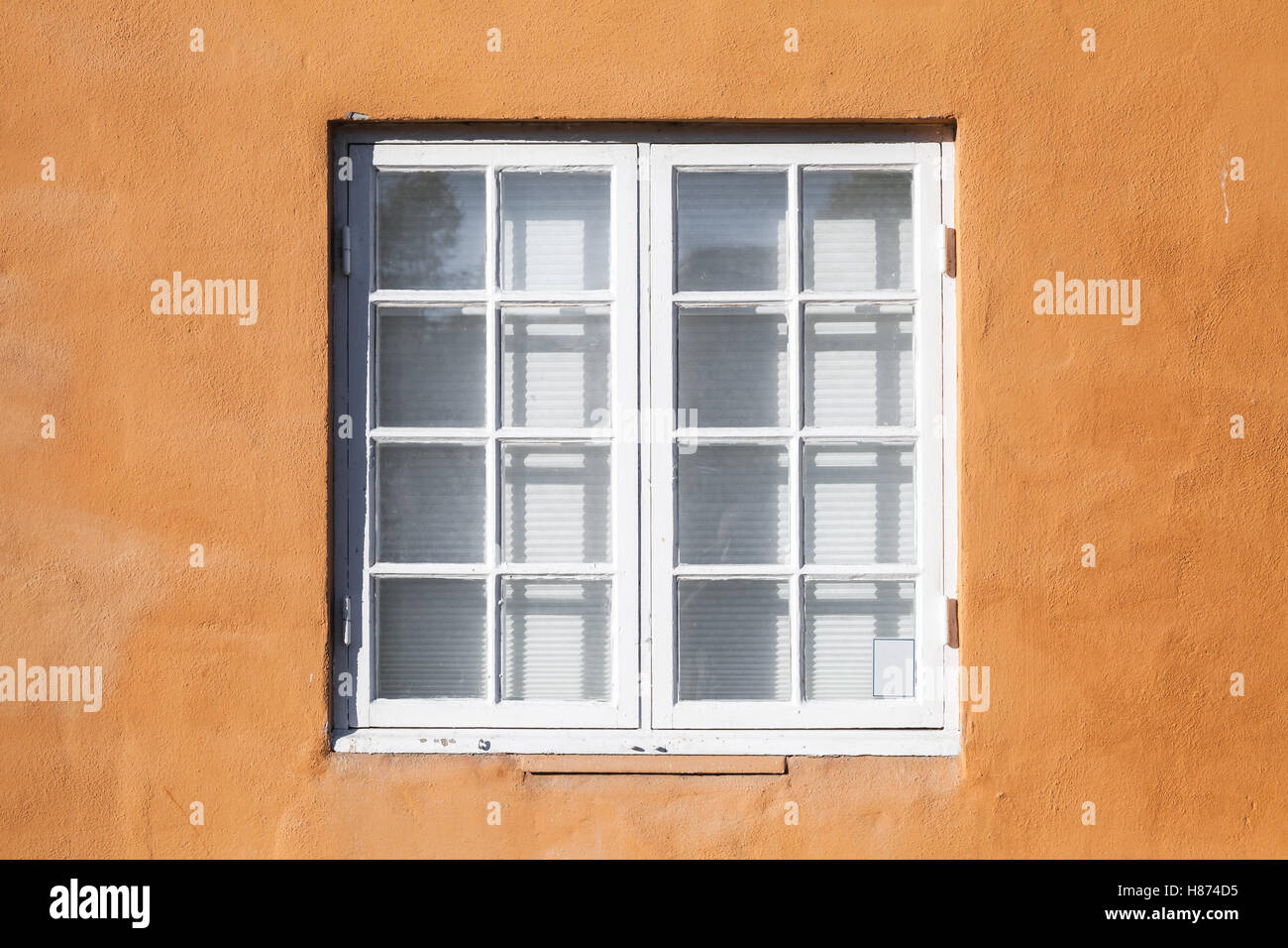 Square window in white wooden frame, yellow wall background photo ...