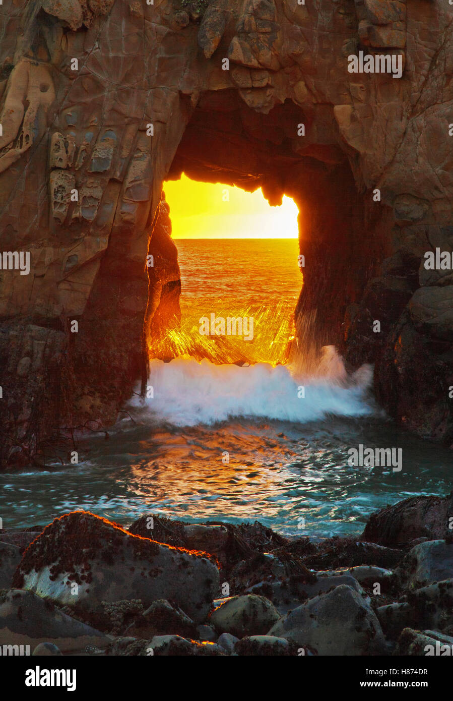 Wave crashing through Keystone Arch at sunset, Pfeiffer Beach, Big Sur ...