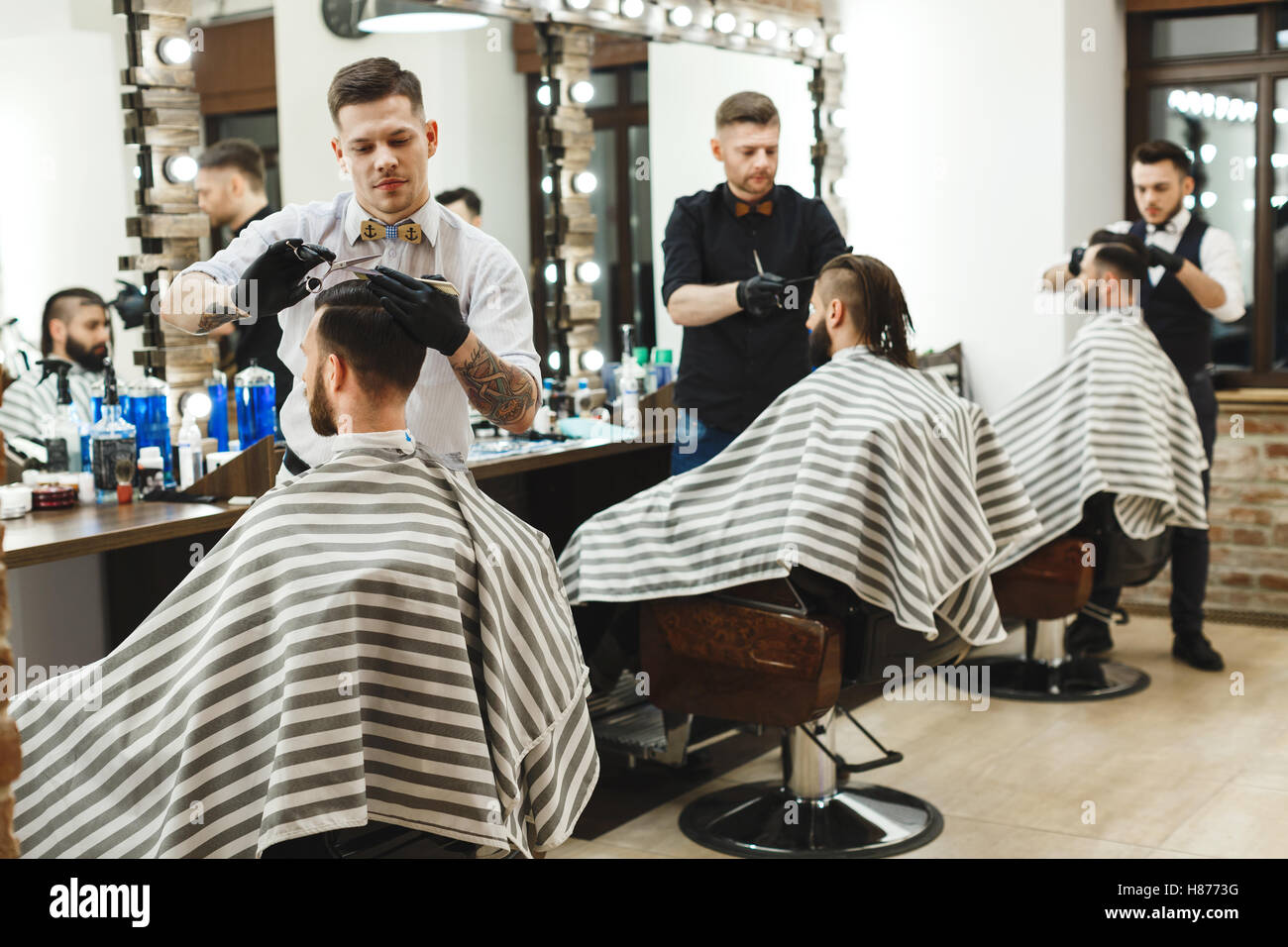 Men at barber shop doing haircuts Stock Photo - Alamy