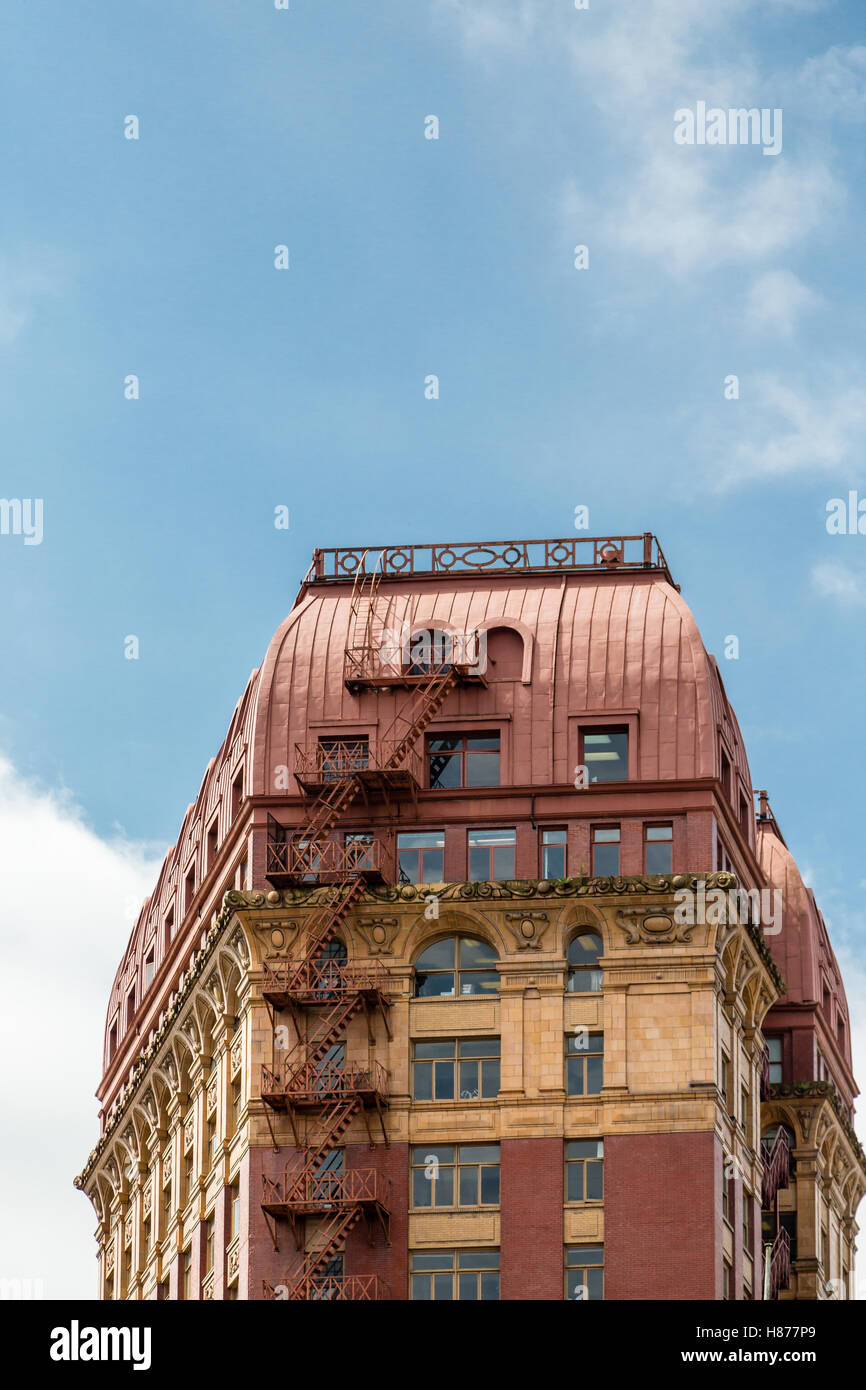 An old red rusty fire escape down a brick building Stock Photo - Alamy