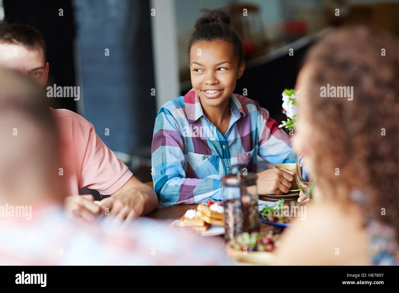 Girl at festive dinner Stock Photo - Alamy