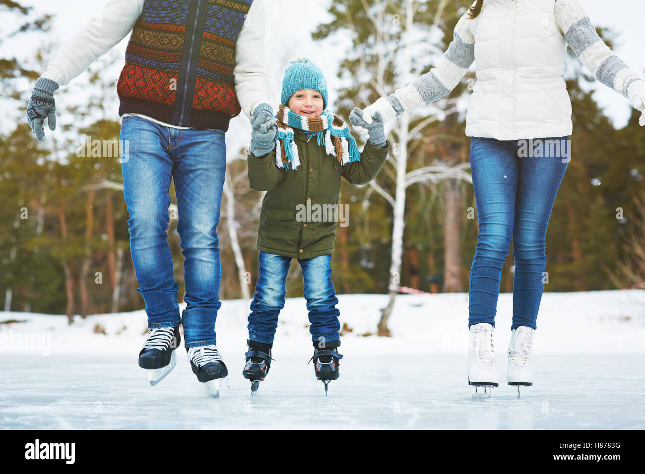 Family ice skating on outdoor rink hi-res stock photography and images ...