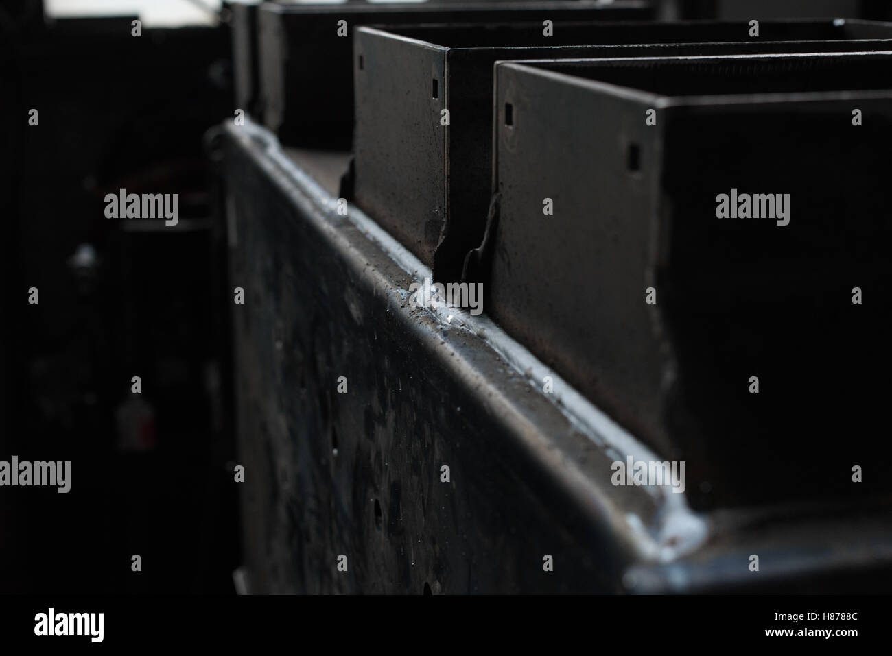 Black steel boxes stand on large container Stock Photo - Alamy