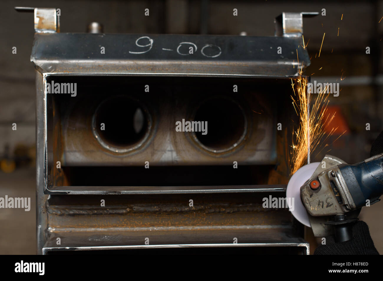 Sparkles of solder machine illuminate black solid fuel boiler Stock ...