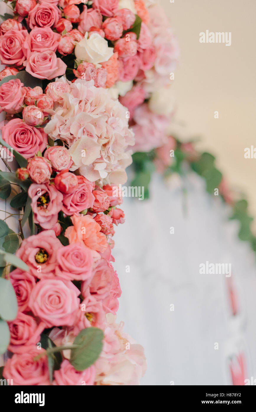 Rich pink flower garland hangs from wedding altar Stock Photo - Alamy