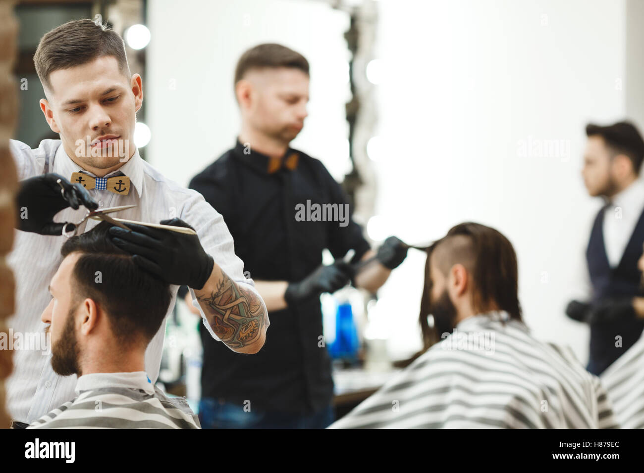 Barbers doing haircuts for clients Stock Photo - Alamy