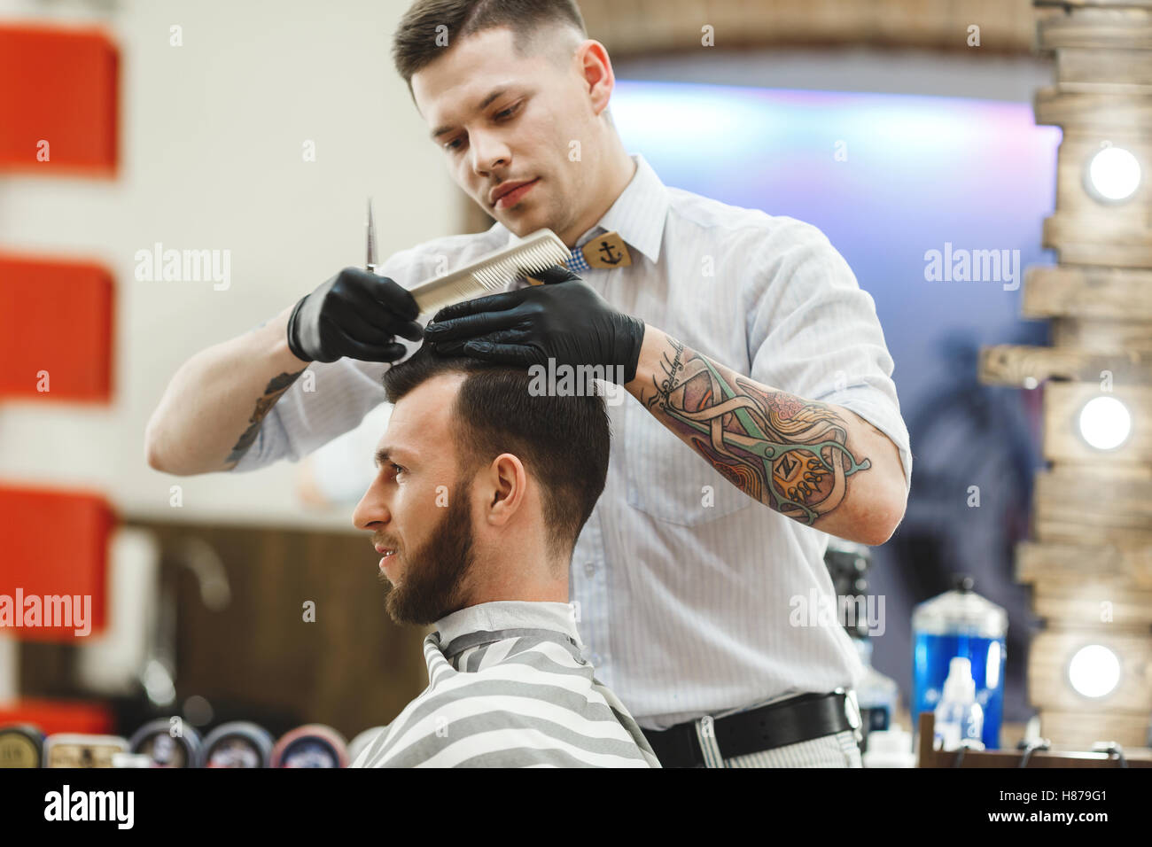 Barber doing haircuts for client Stock Photo - Alamy