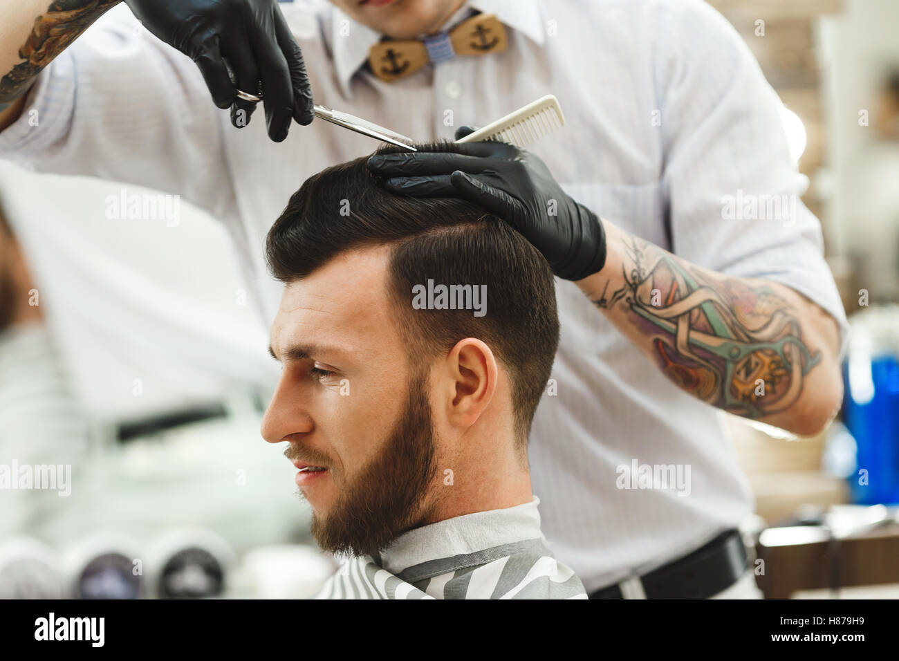 Barber doing haircuts for client Stock Photo - Alamy