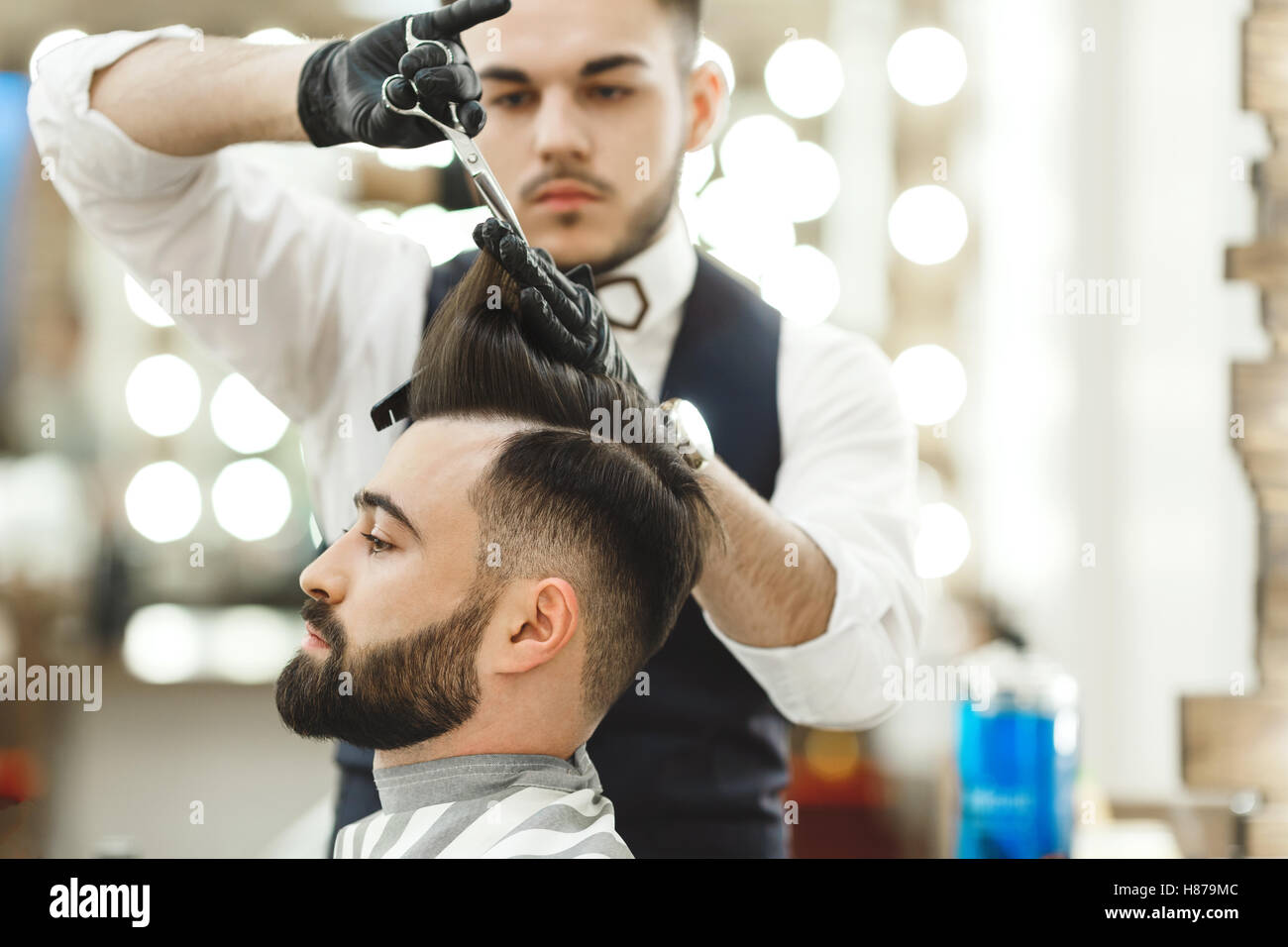 Barber doing haircuts for client Stock Photo - Alamy