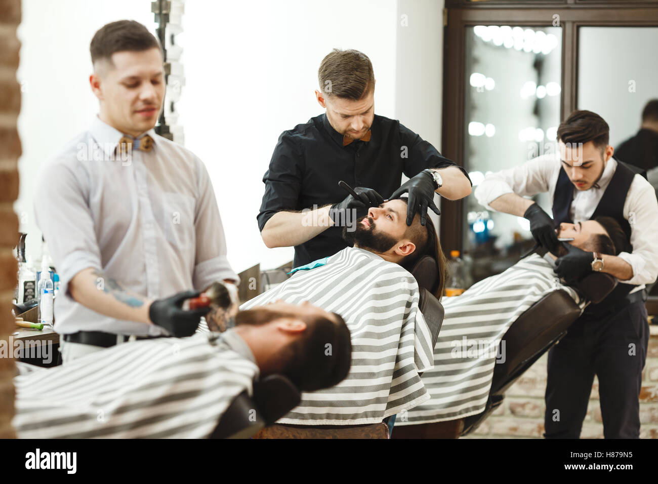 Barbers making a beard form for clients Stock Photo - Alamy