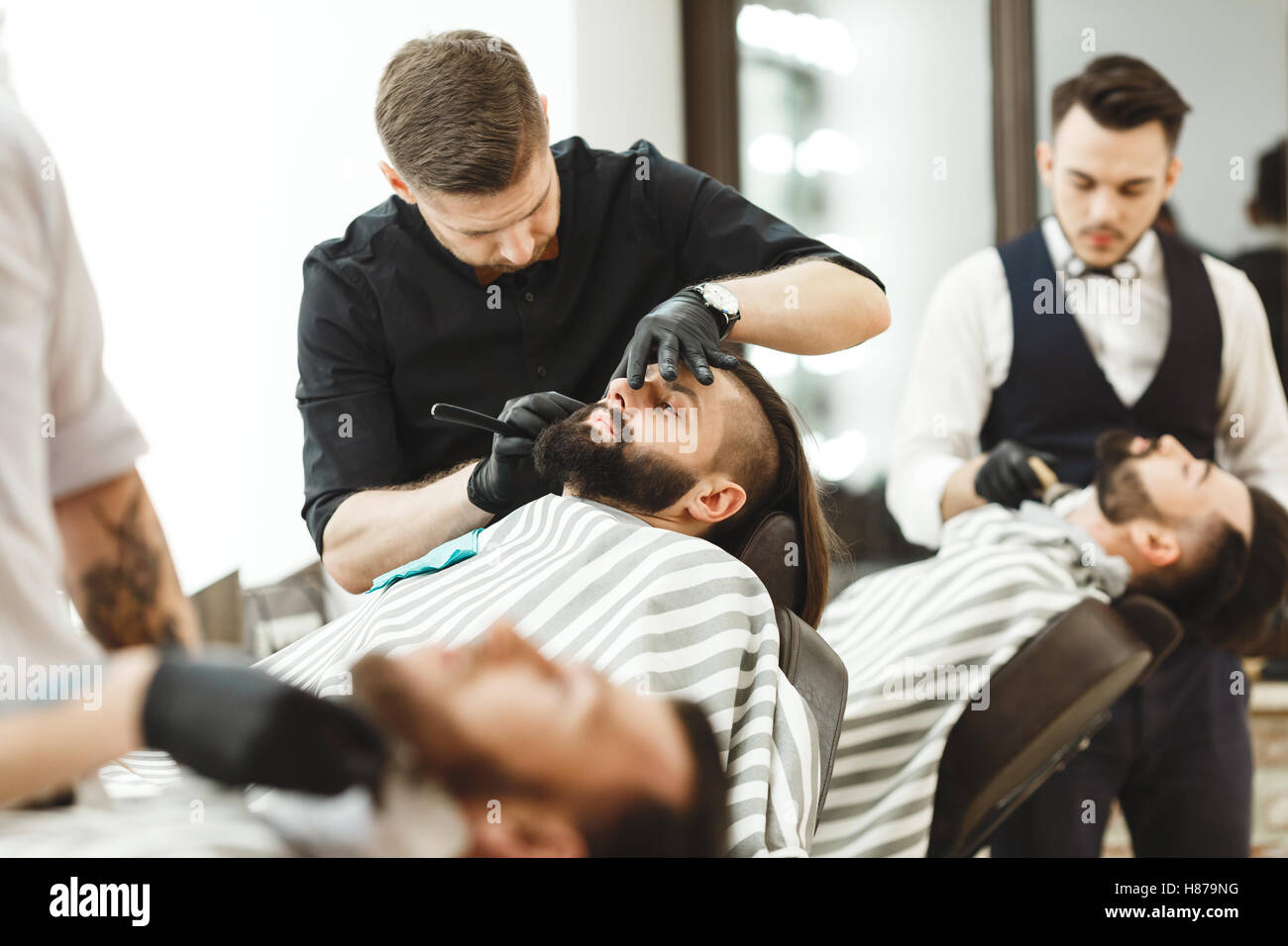 Barbers making a beard form for clients Stock Photo - Alamy
