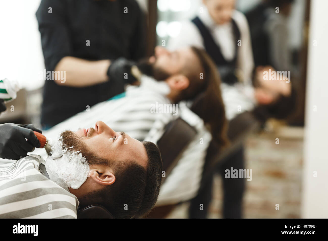 Barbers making a beard form for clients Stock Photo - Alamy