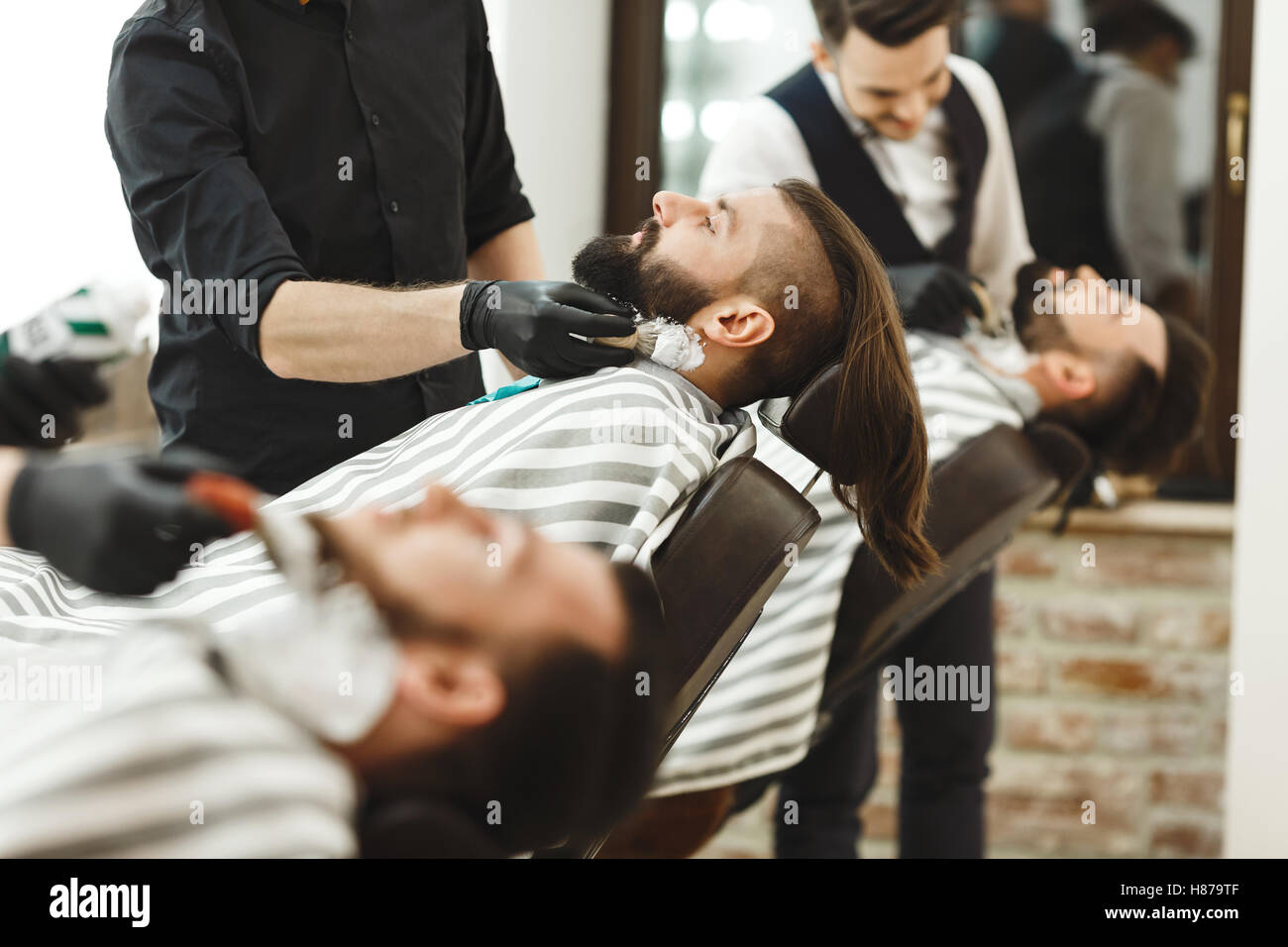 Barbers making a beard form for clients Stock Photo - Alamy