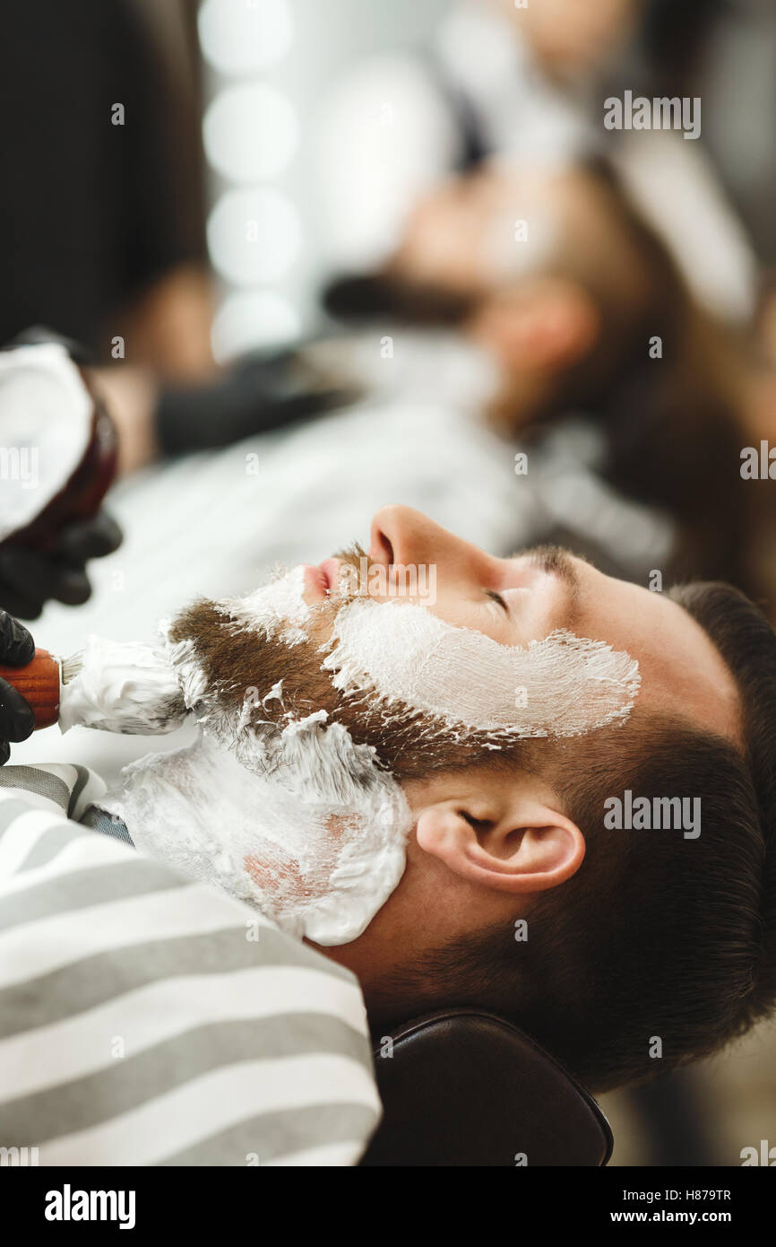 Barbers making a beard form for clients Stock Photo - Alamy