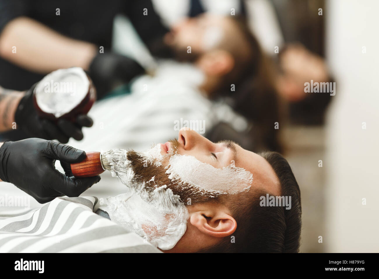 Barbers making a beard form for clients Stock Photo - Alamy