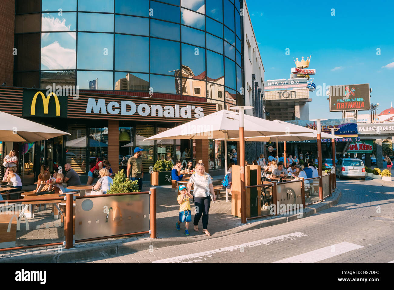 Minsk, Belarus. Mid Adult Plus Size Woman Mother Leading Her Son Of ...