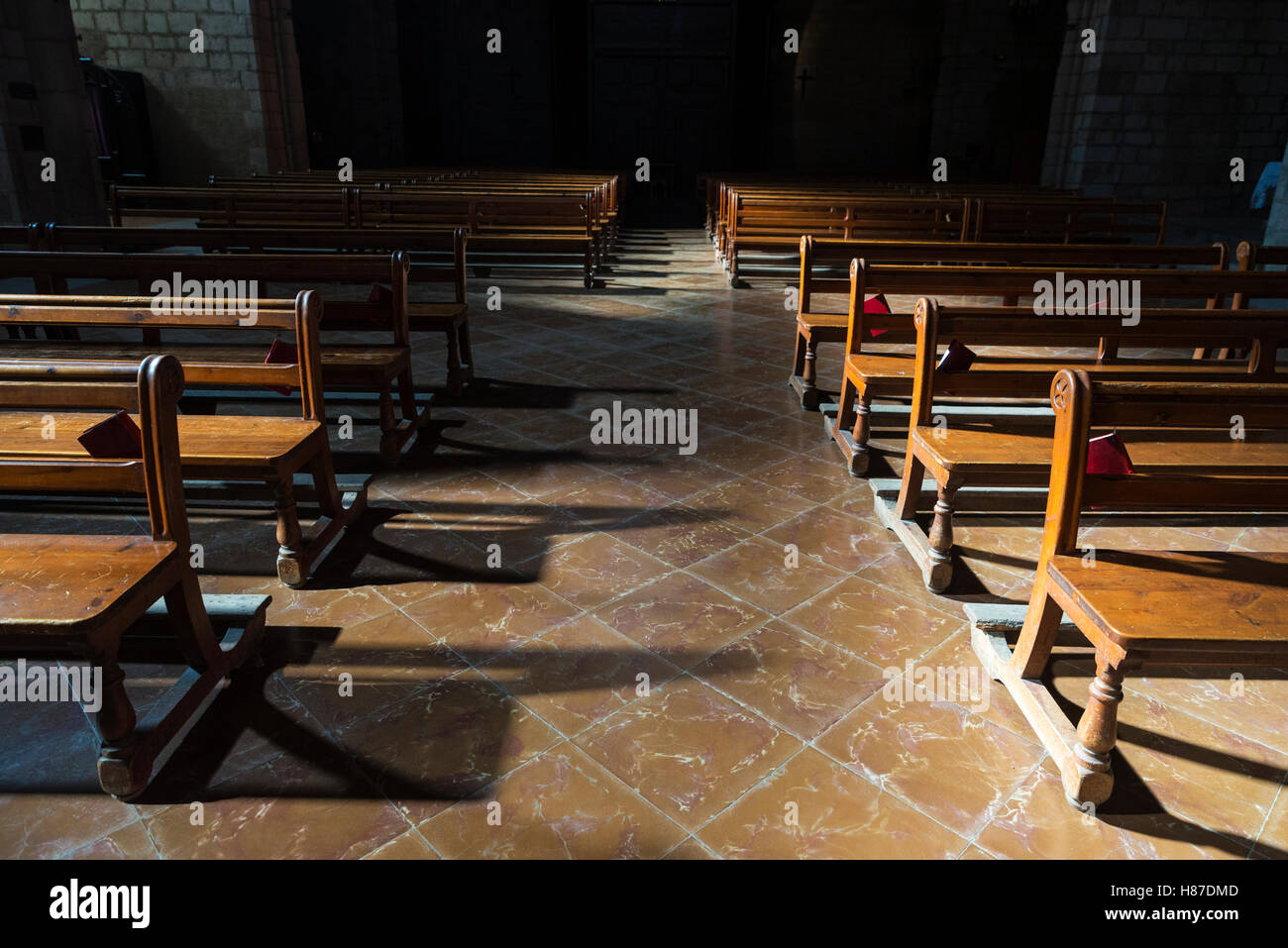 Row of wooden benches inside a church in Spain Stock Photo - Alamy