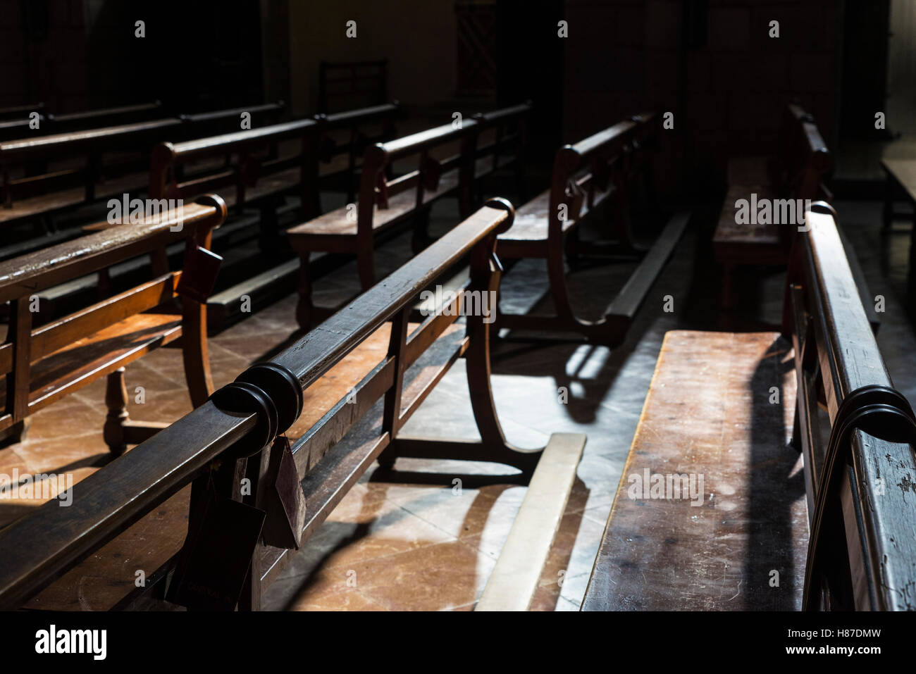 Row of wooden benches inside a church in Spain Stock Photo - Alamy