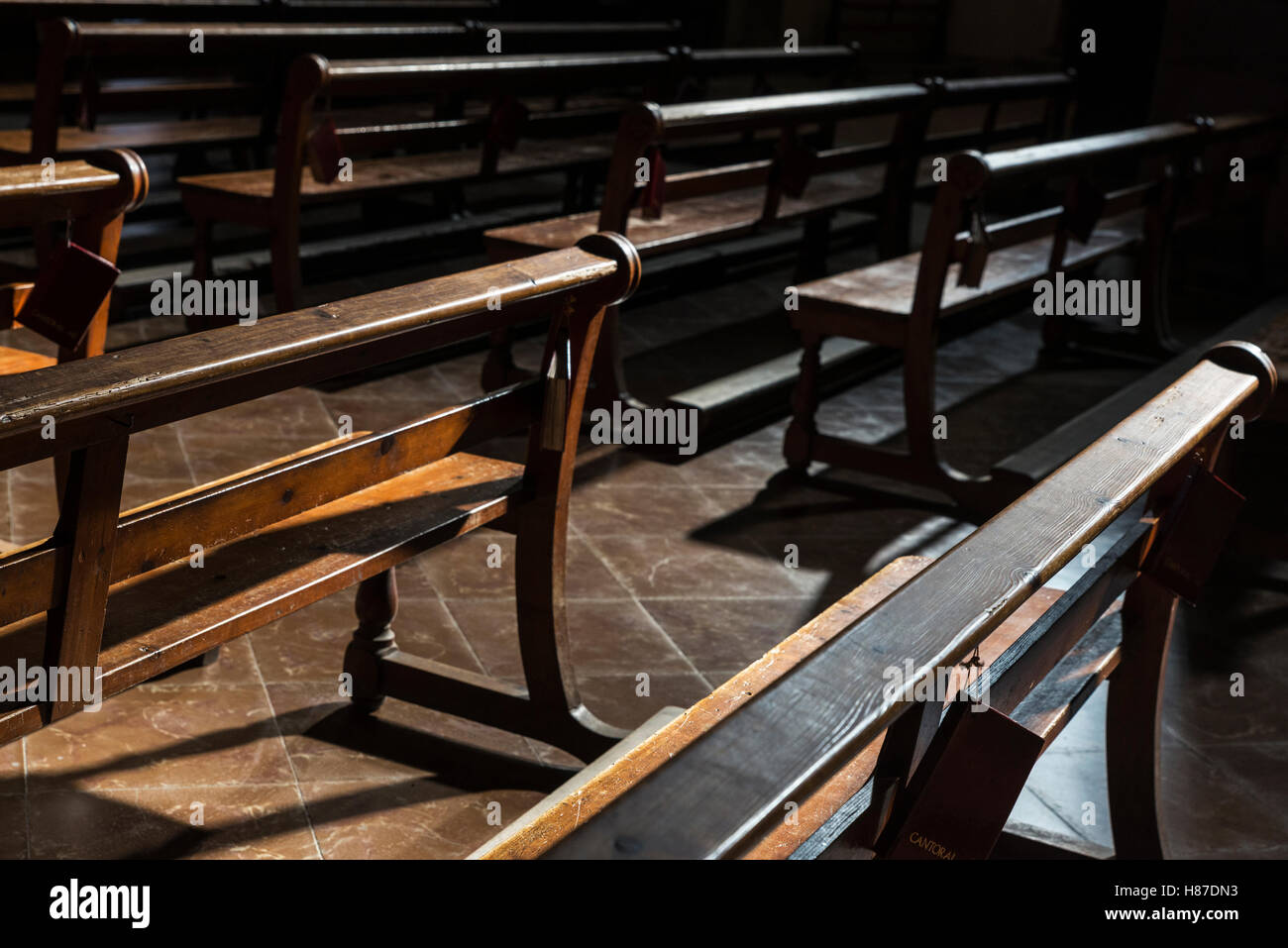 Row of wooden benches inside a church in Spain Stock Photo - Alamy